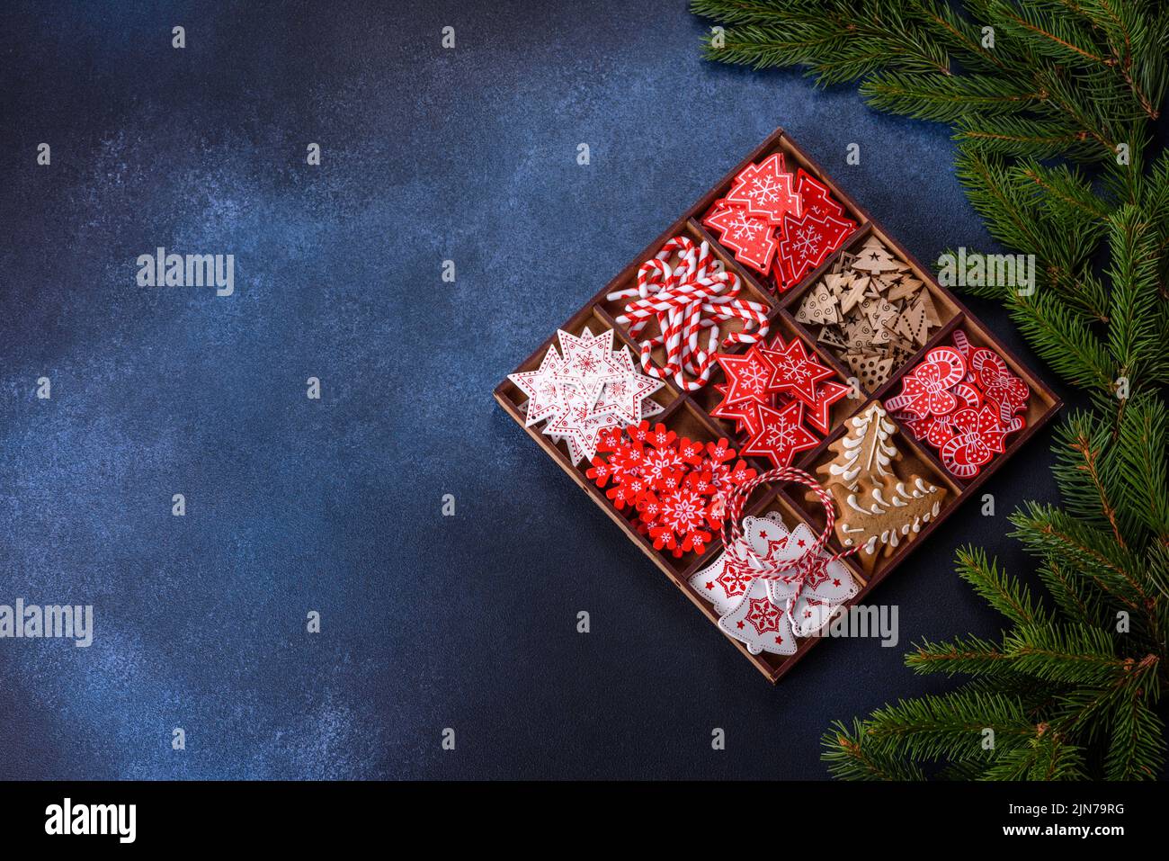 Christmas toys in white and red in a wooden sectional box against a ...
