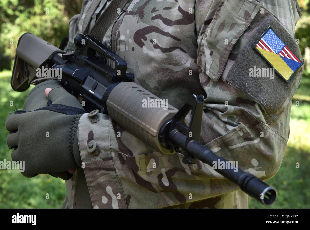 Soldier with assault rifle. Military volunteer. Military legionary ...