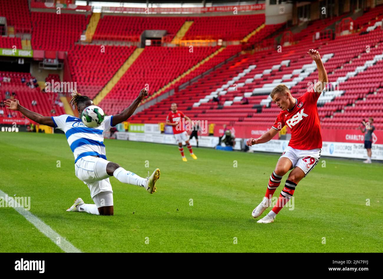 Charlton Athletic's Charles Clayden (right) shoots the ball past Queens ...