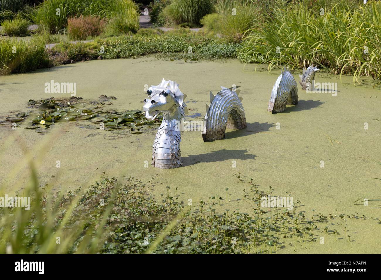 A sea serpent sculpture made of discarded soda cans, on display at the ...