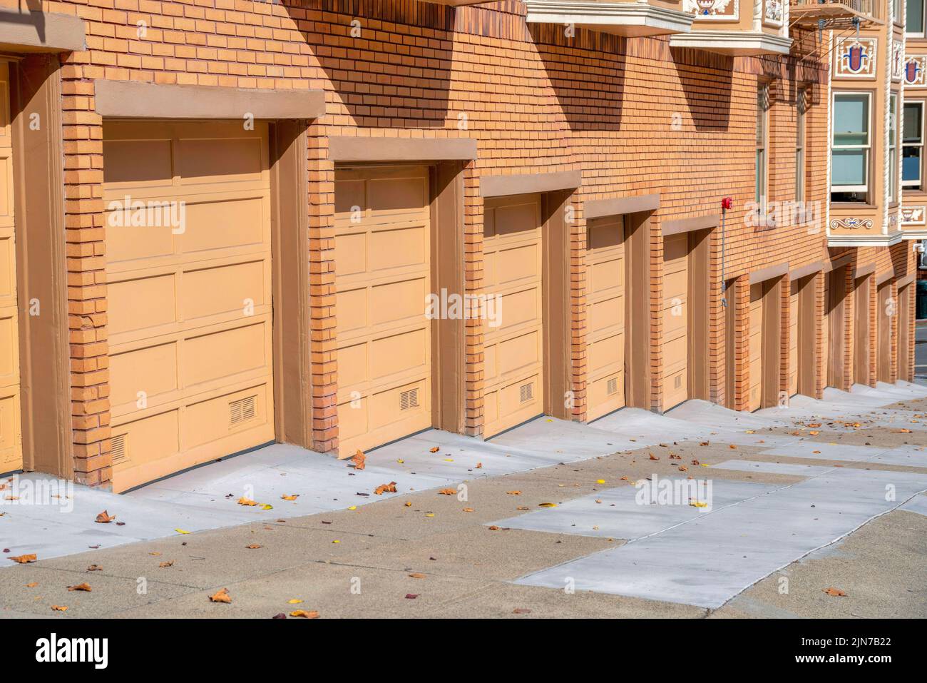 Downhill garage doors of an apartment building in San Francisco ...