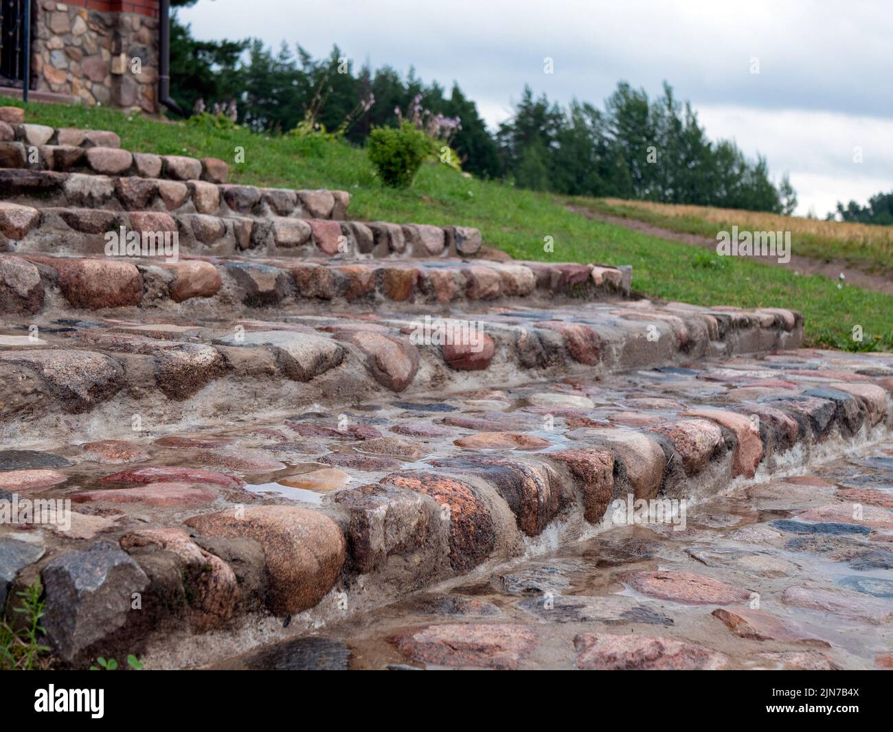 Cobblestone staircase placed at the entrance to the house. Porch and ...