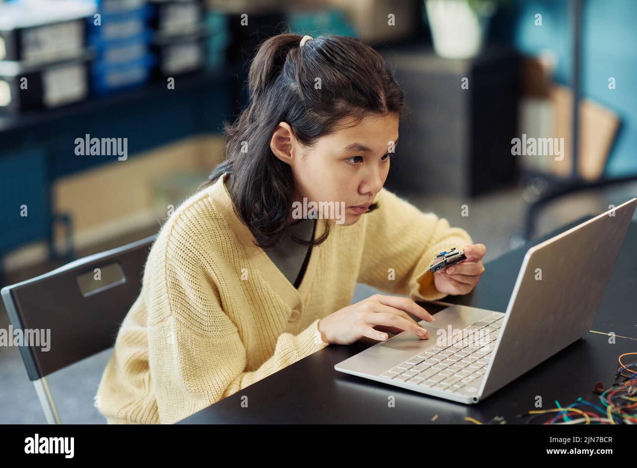 Portrait of young Asian girl using laptop in engineering class and ...