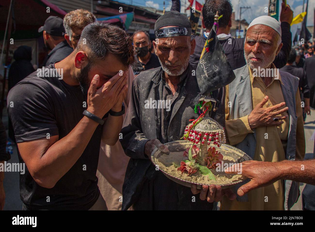 Shiite mourners apply sacred dust obtained from Karbala during mourning ...
