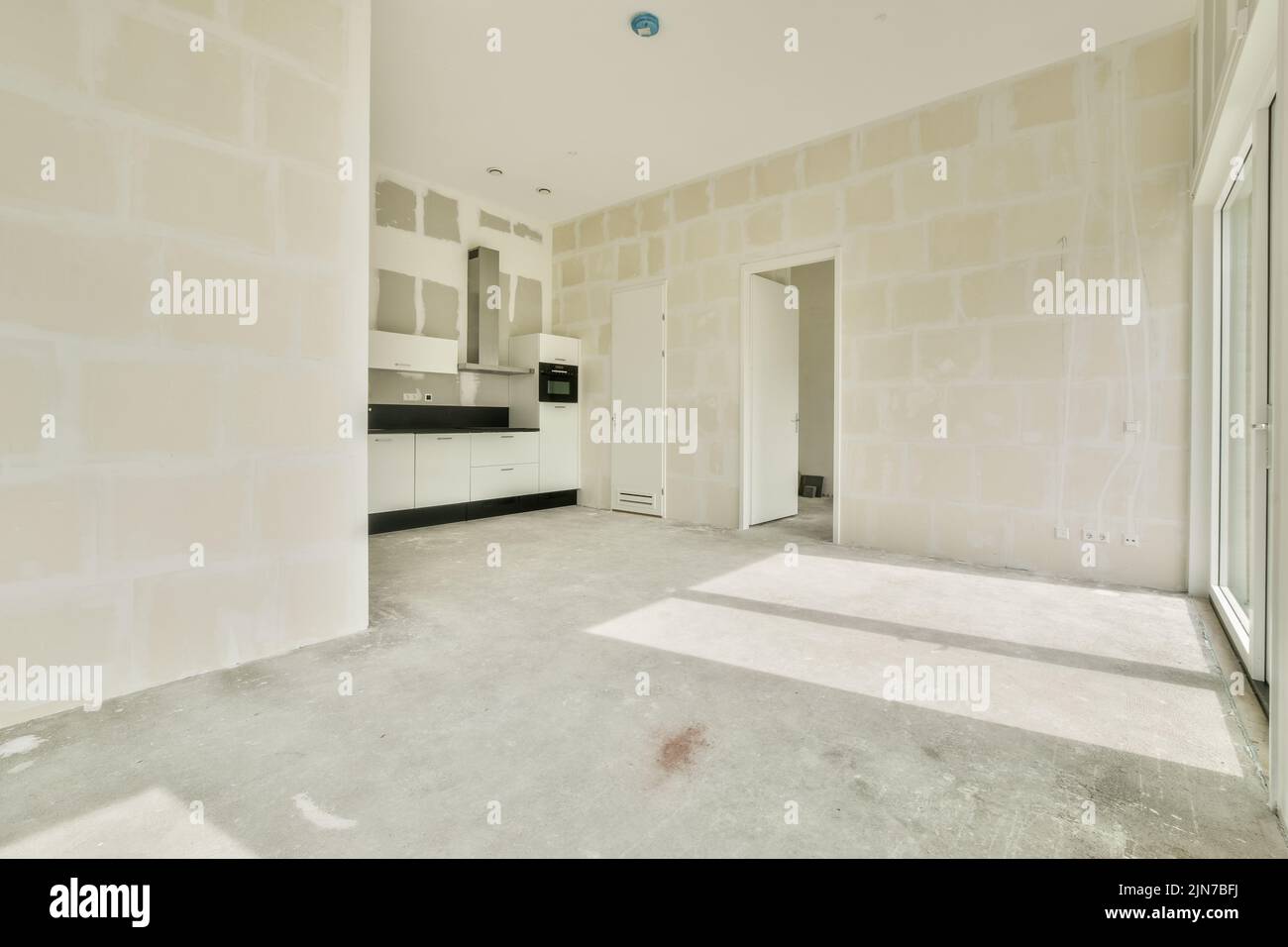 Interior of empty white kitchen with windows and wooden parquet floor ...