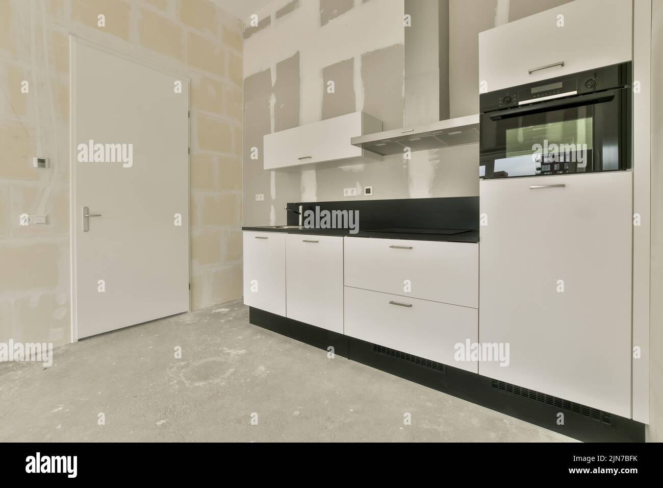 Interior of empty white kitchen with windows and wooden parquet floor ...