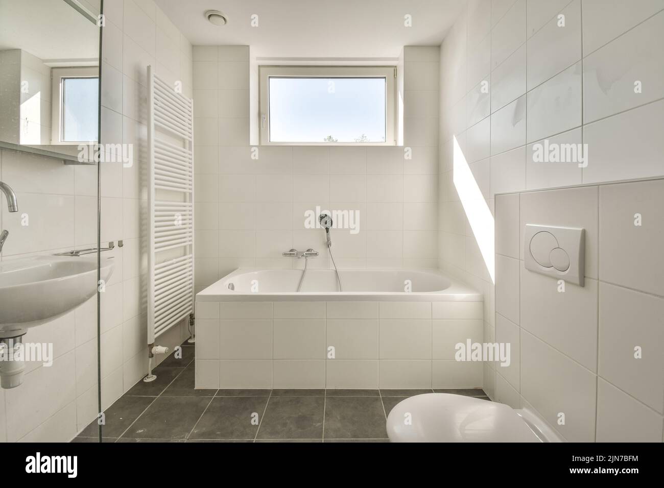 Modern home interior design of white bathroom with open bathtub and ...