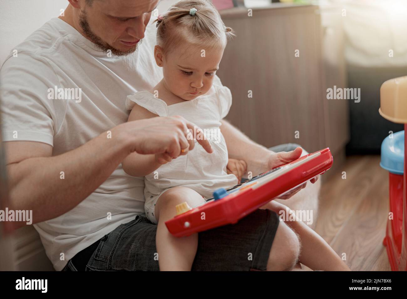 Close up of handsome father with his child playing together using toys ...