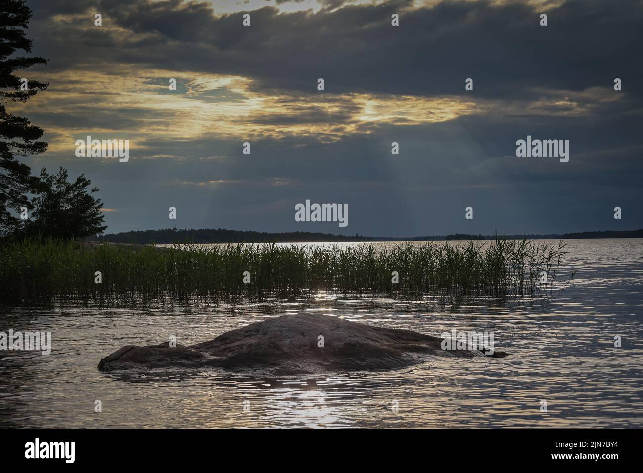The evening sun breaks through the cloud cover on Kabetogama Lake ...