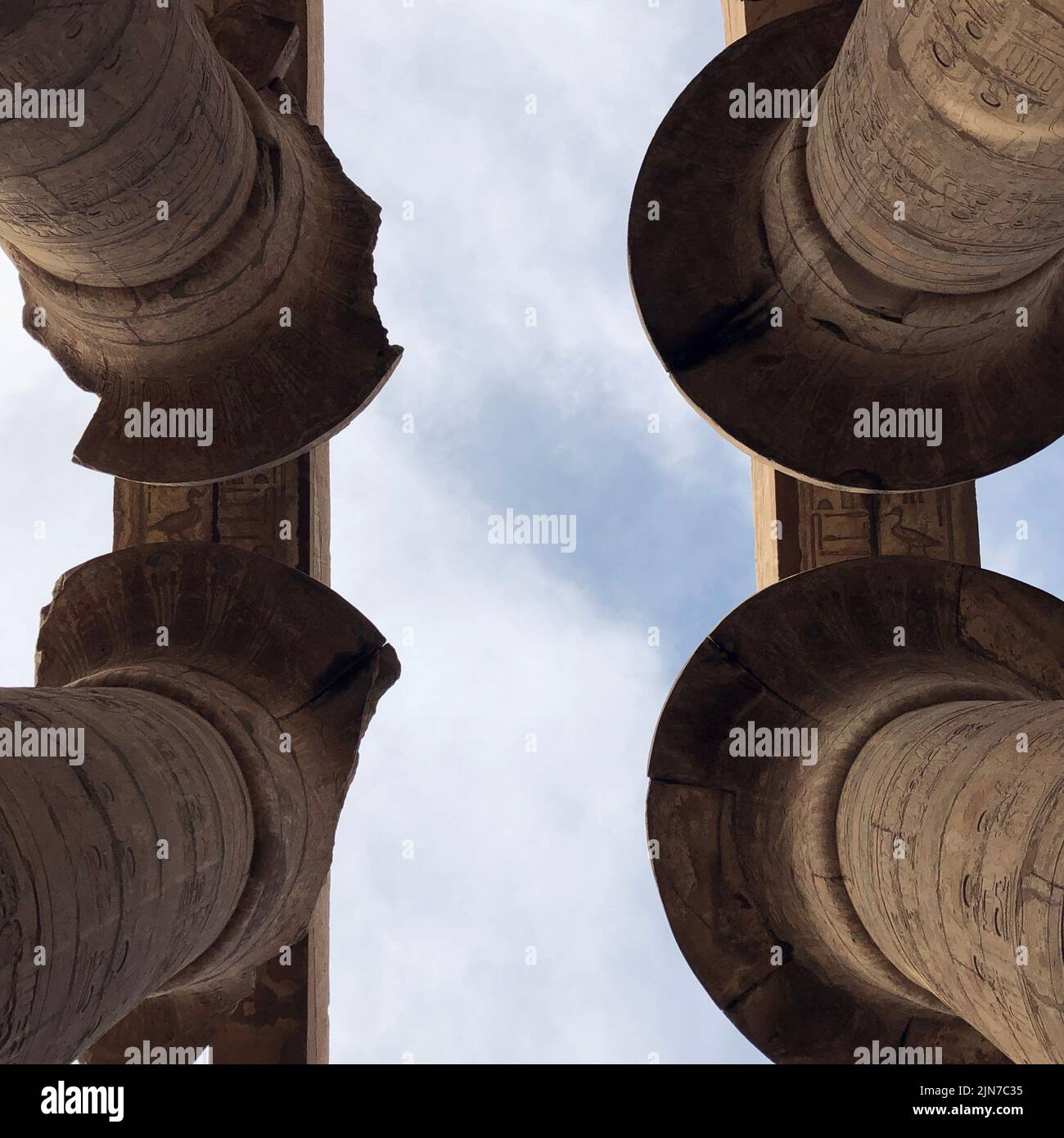 A low angle shot of stone bricks with Egyptian carvings in Luxor Temple ...