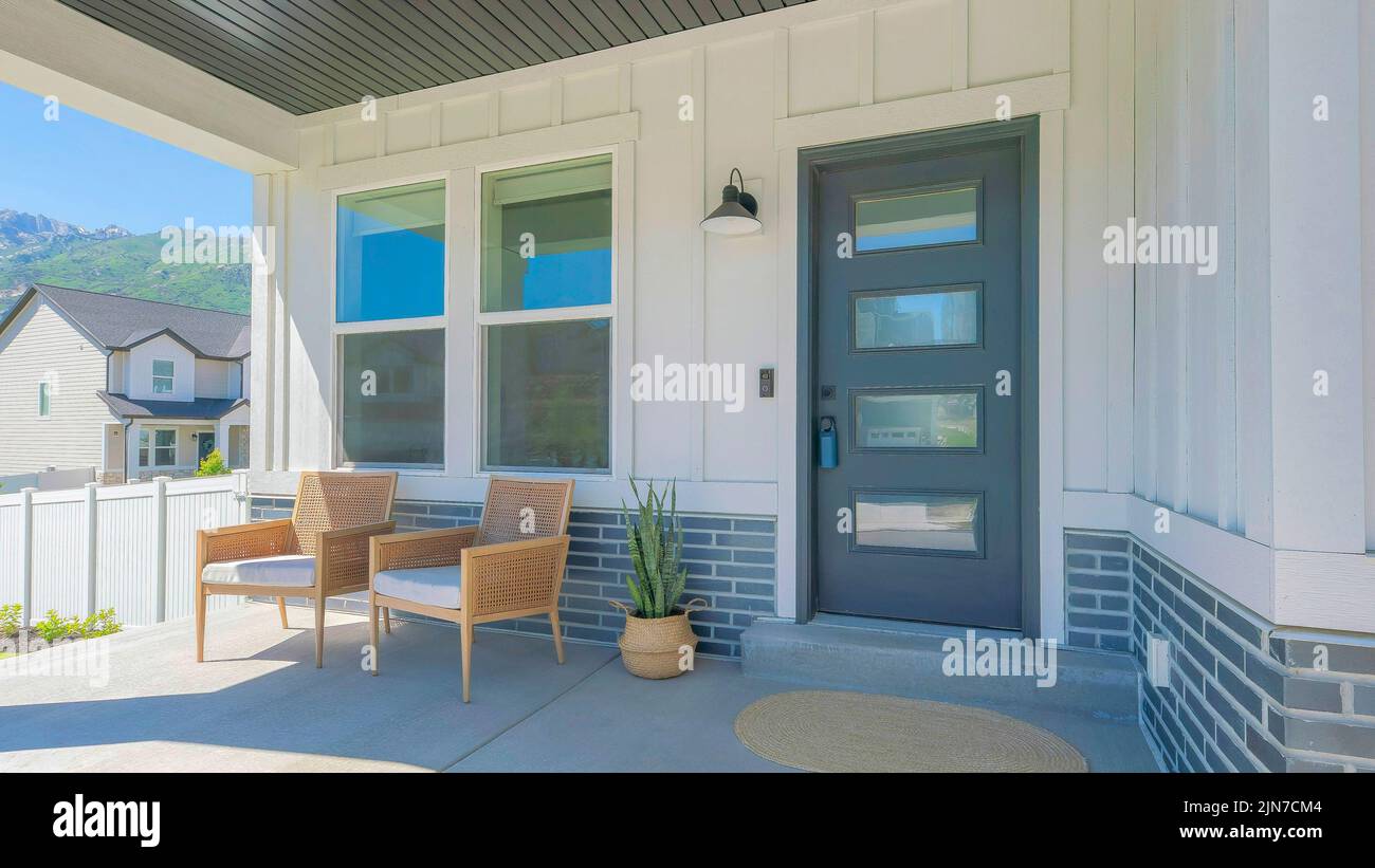 Panorama Porch with two woven armchairs and snake plant on a woven pot ...