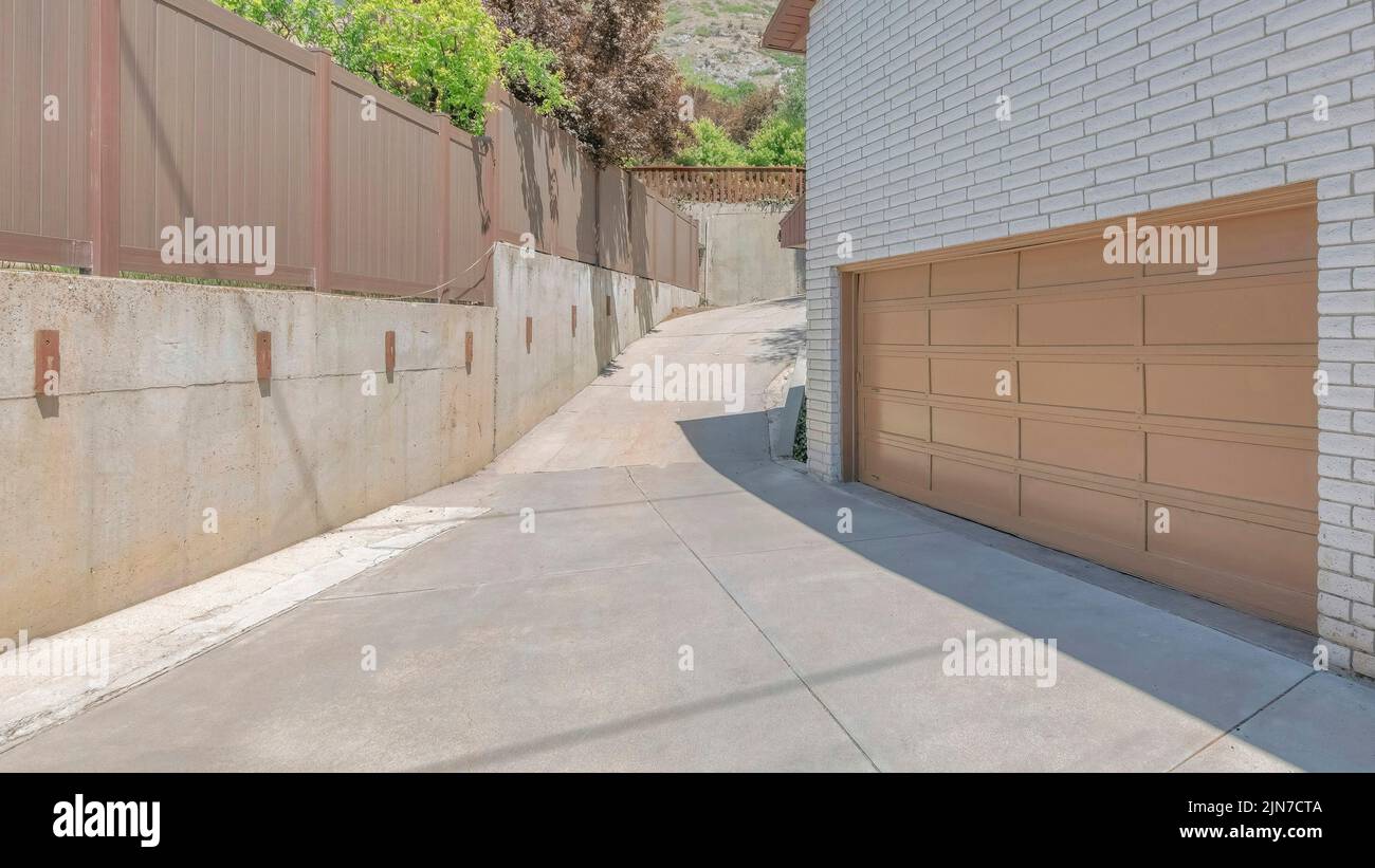 Panorama White puffy clouds Uphill curved driveway beside the garage ...