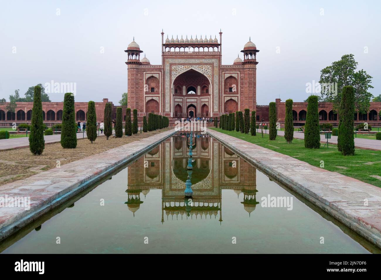 A shot of the Royal Gate with the reflection in a pool of water in ...