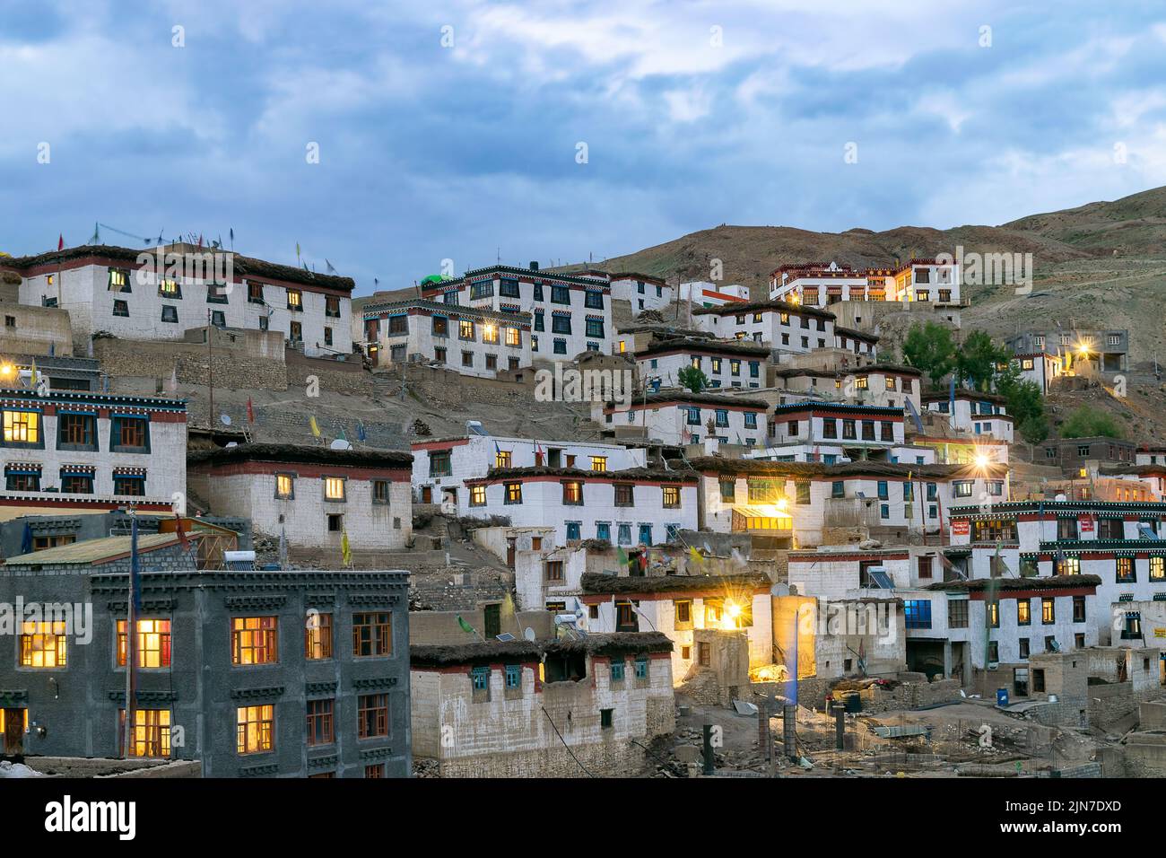 The famous Kibber village in India on an evening with lights on and a ...