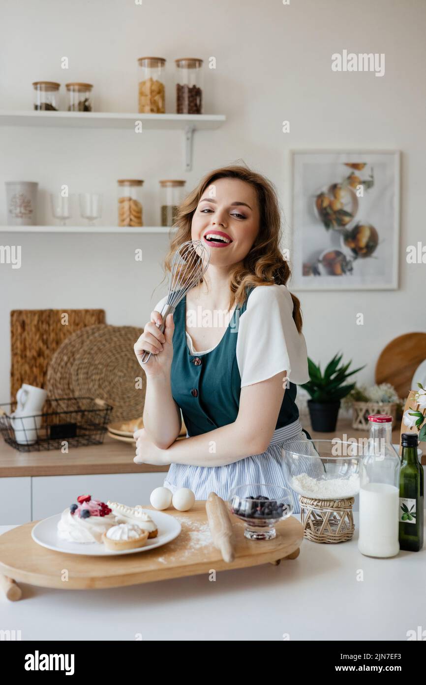 Pretty adult girl cooking in the kitchen Stock Photo - Alamy