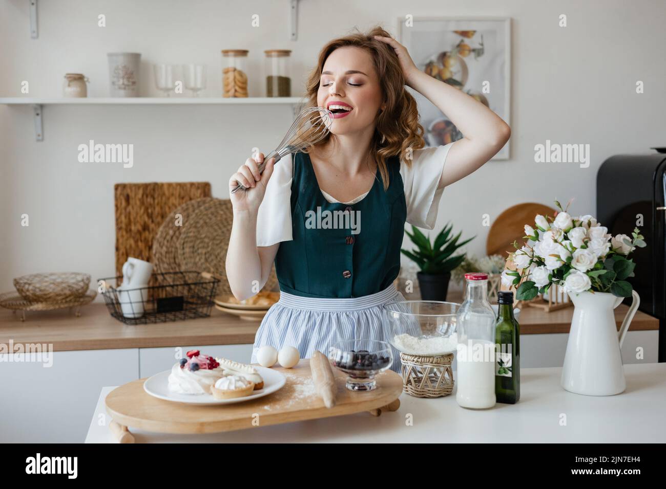 Pretty adult girl cooking in the kitchen Stock Photo - Alamy