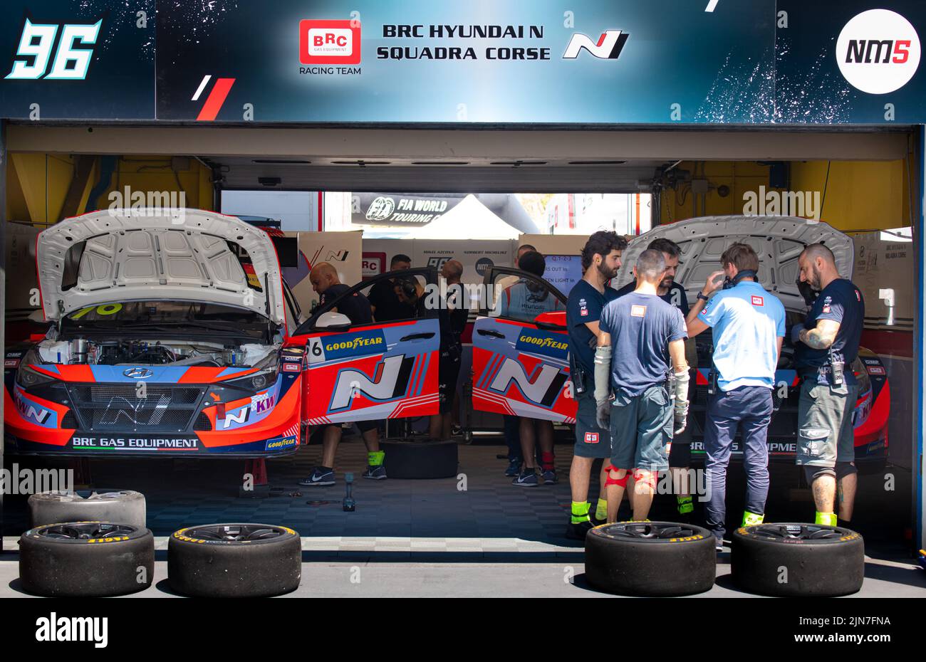 Hyundai race cars in team garage with mechanics tuning. Vallelunga ...