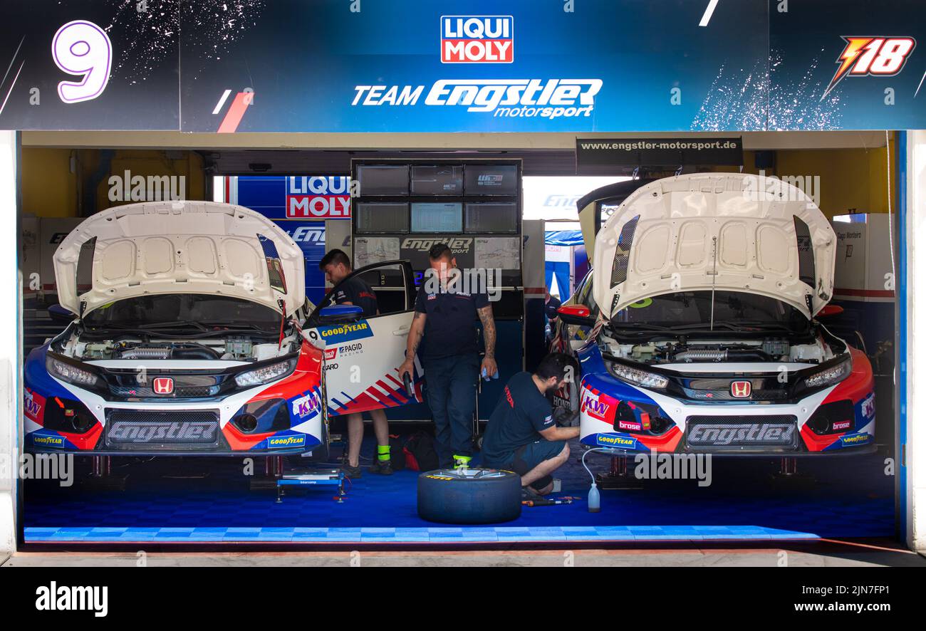 Honda race cars in team garage with mechanics tuning. Vallelunga, Italy ...