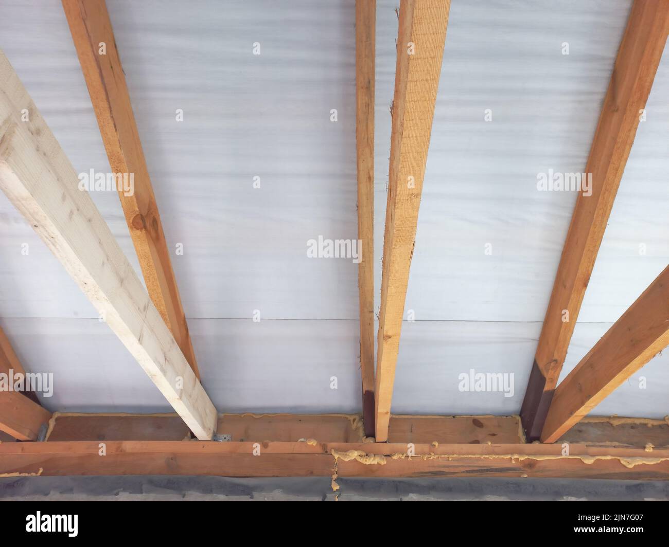 A new roof of a house shot from inside close up - wooden beams ...