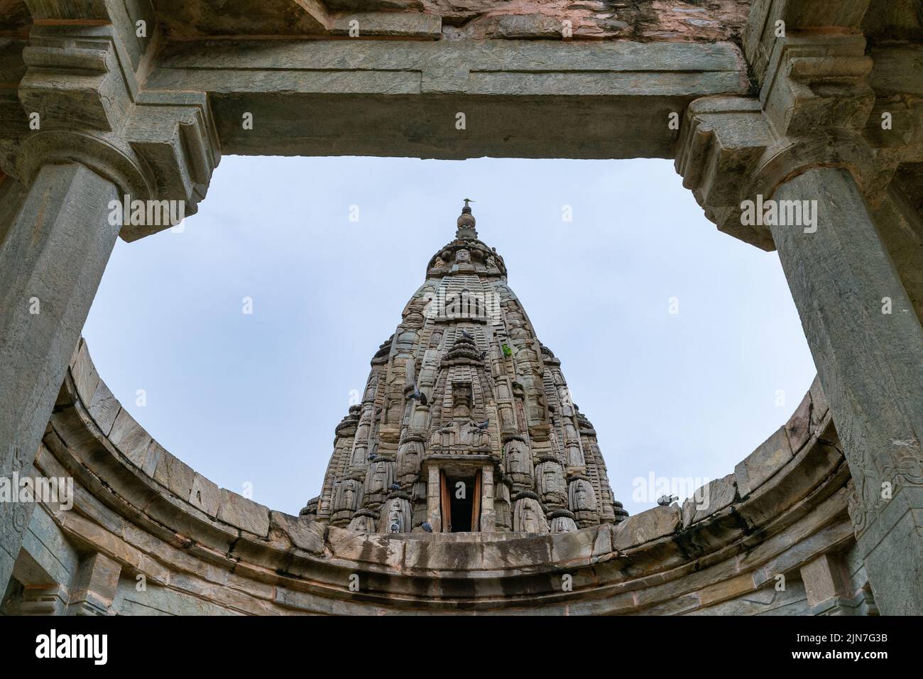A low angle shot of the Rameshwar Temple seen from an arched structure ...