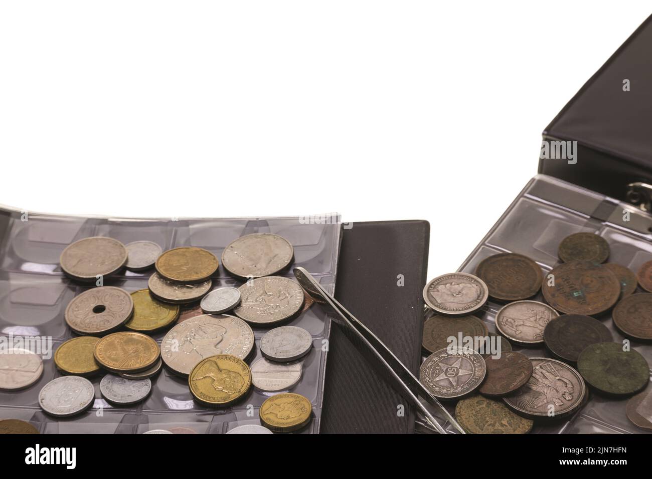 Close up view of coins collection in different condition and tweezers ...