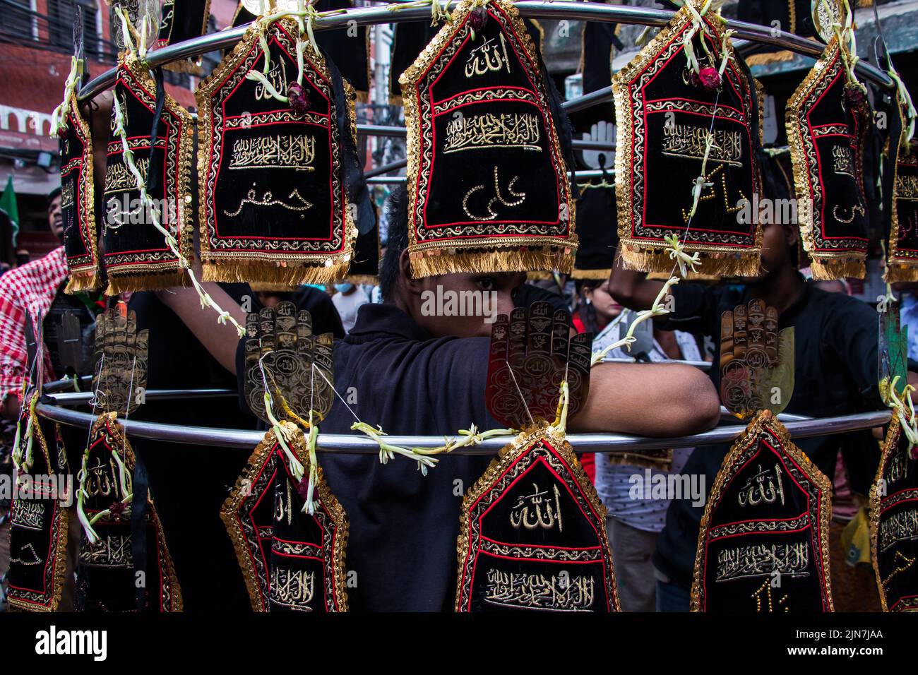 Bangladeshi Shia Muslims march and carry the flags and Tazia during a ...
