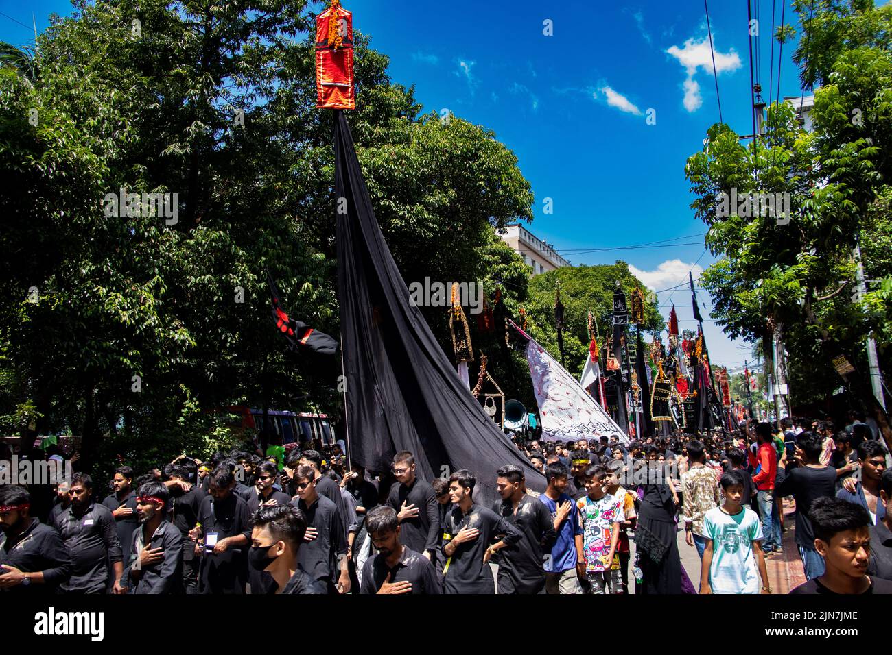 Bangladeshi Shia Muslims march and carry the flags and Tazia during a ...