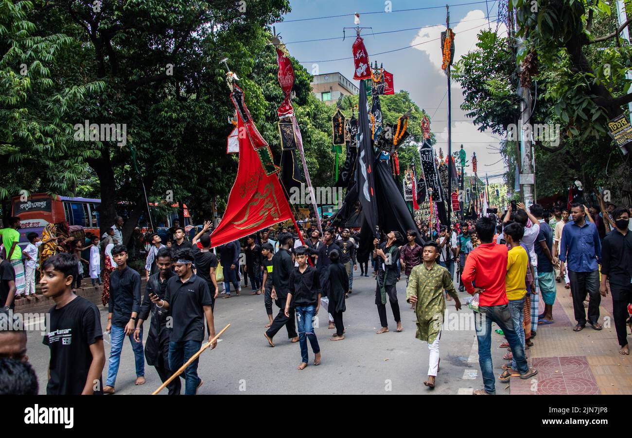Bangladeshi Shia Muslims march and carry the flags and Tazia during a ...