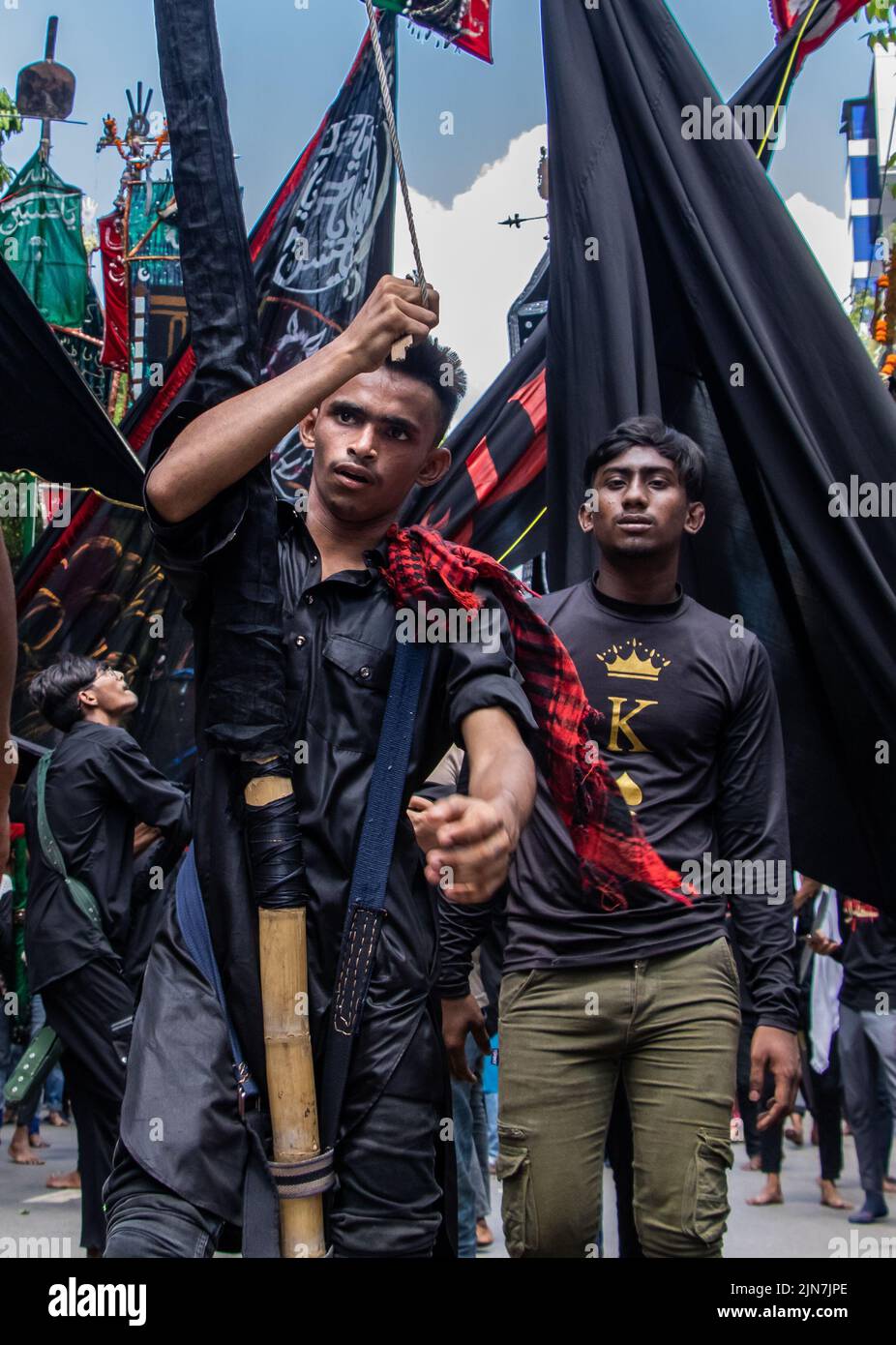 Bangladeshi Shia Muslims march and carry the flags and Tazia during a ...