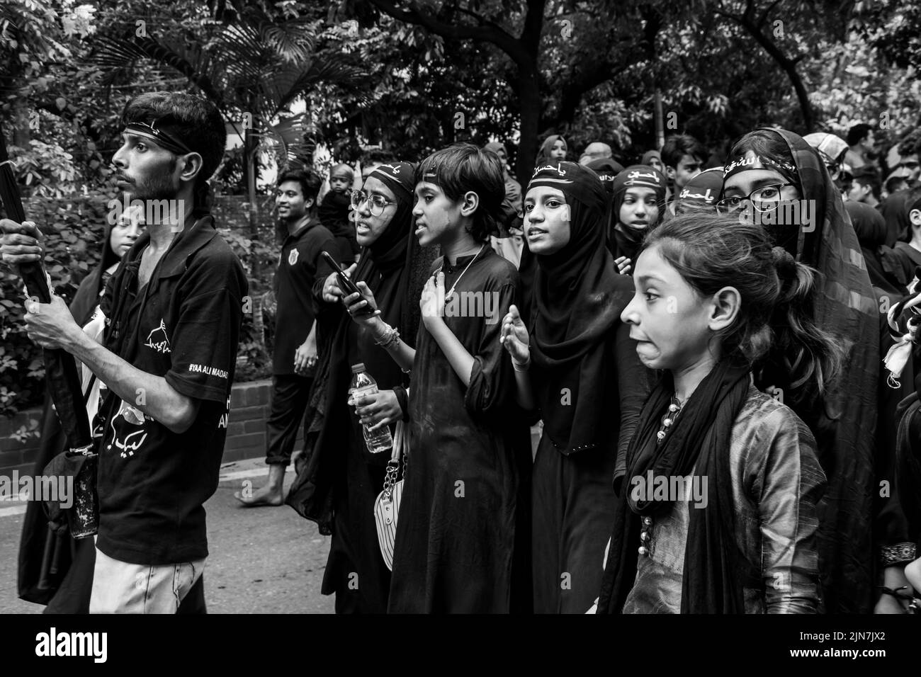 Bangladeshi Shia Muslims march and carry the flags and Tazia during a ...