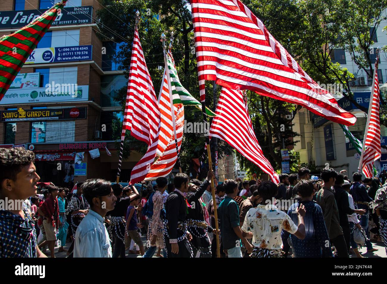 Bangladeshi Shia Muslims march and carry the flags and Tazia during a ...