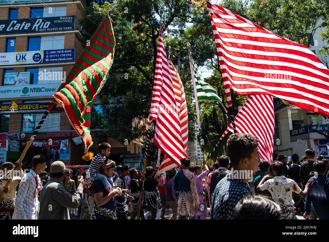Bangladeshi Shia Muslims march and carry the flags and Tazia during a ...