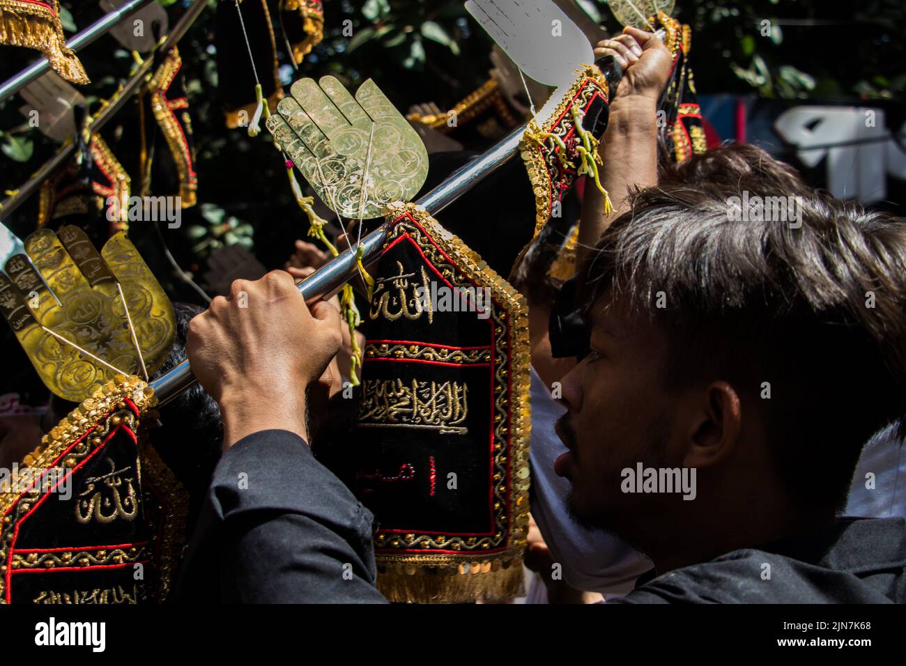 Bangladeshi Shia Muslims march and carry the flags and Tazia during a ...