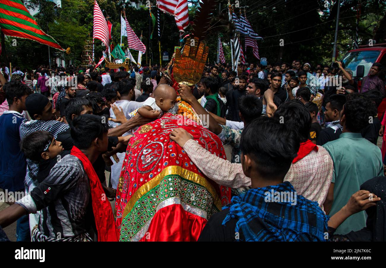 Bangladeshi Shia Muslims march and carry the flags and Tazia during a ...