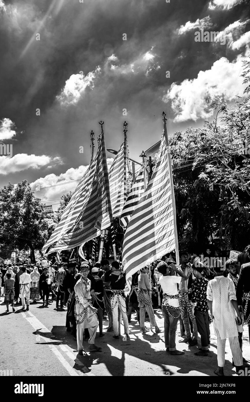 Bangladeshi Shia Muslims march and carry the flags and Tazia during a ...