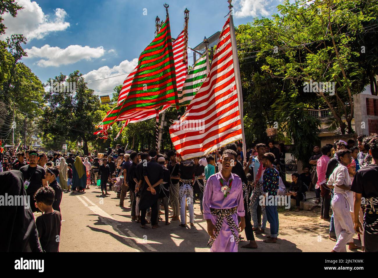 Bangladeshi Shia Muslims march and carry the flags and Tazia during a ...