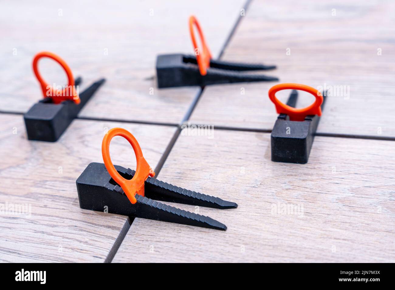 close-up of the tile alignment system holding tile in given position ...