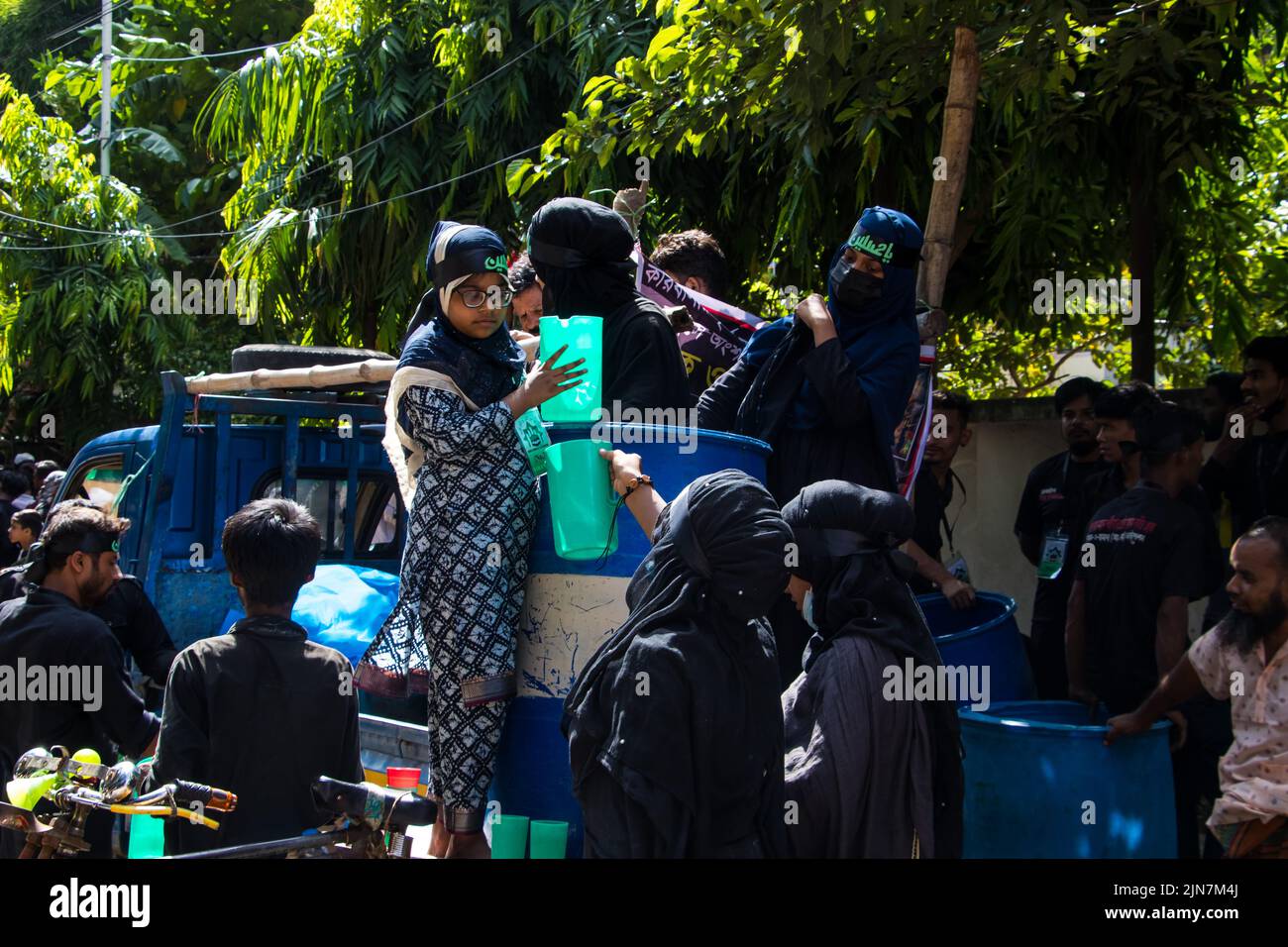 Bangladeshi Shia Muslims march and carry the flags and Tazia during a ...