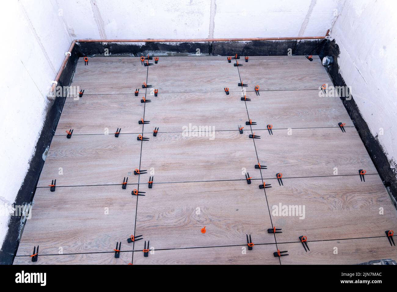 close-up of the tile alignment system holding tile in given position ...
