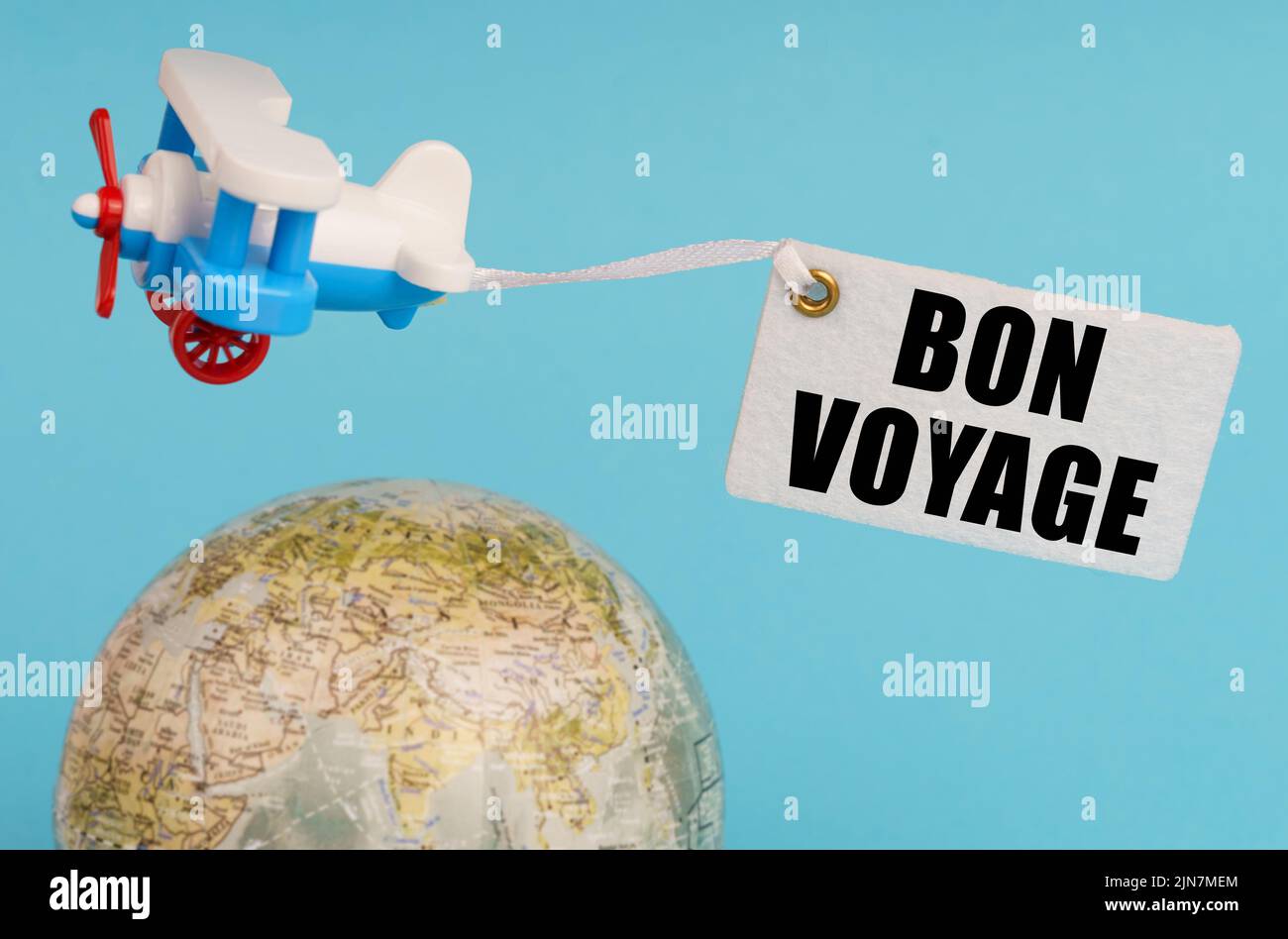 Travel and business concept. On a blue background, a globe and an ...