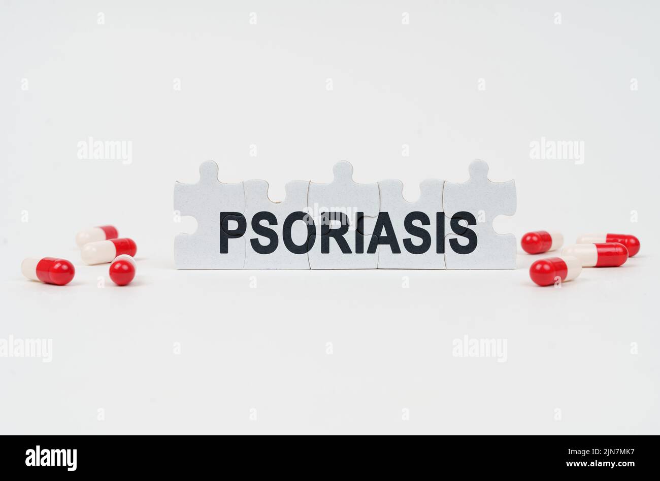 Medical concept. On a white surface are tablets and puzzles with the ...