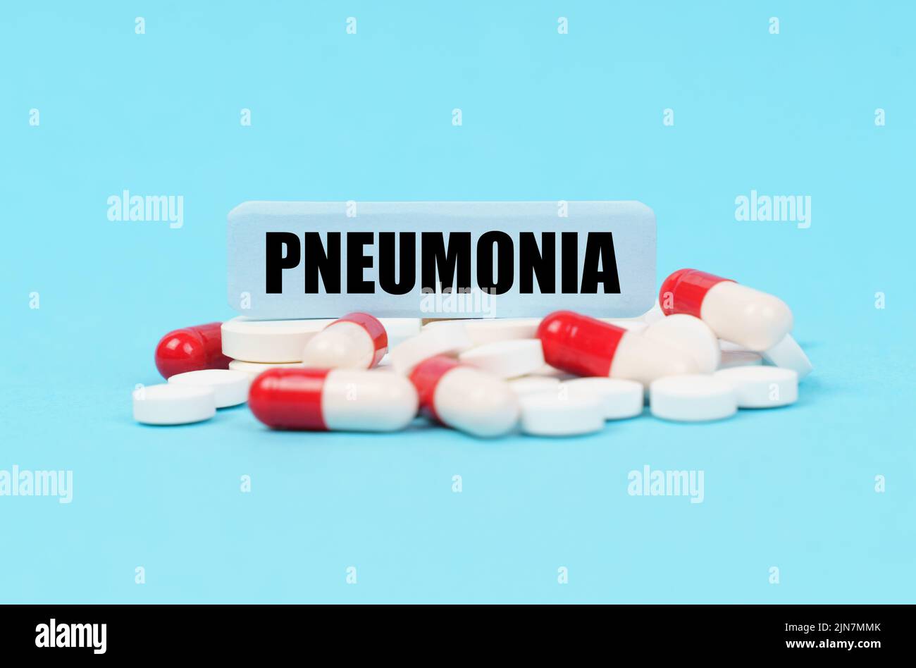 Medical concept. On the blue surface of the pills, capsules and a plate ...