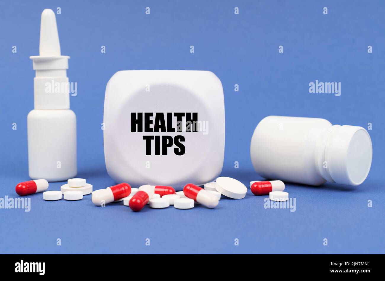Medical concept. On the blue surface of the pill, capsule, spray, jar ...