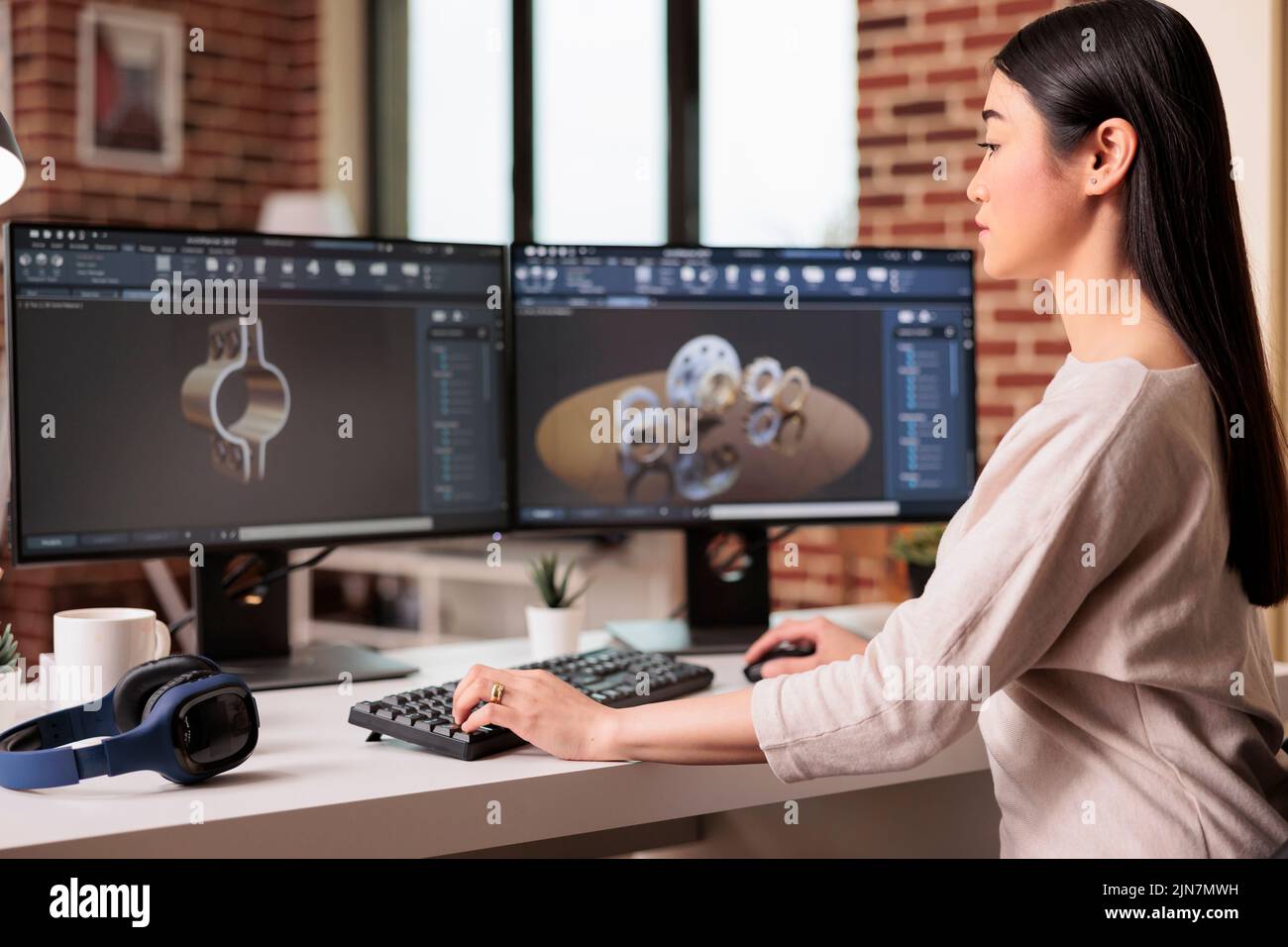 Woman technician working on product development with gears and engine ...