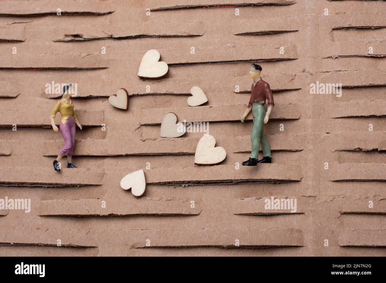 Tiny figurine of man and woman miniature model and heart as love ...