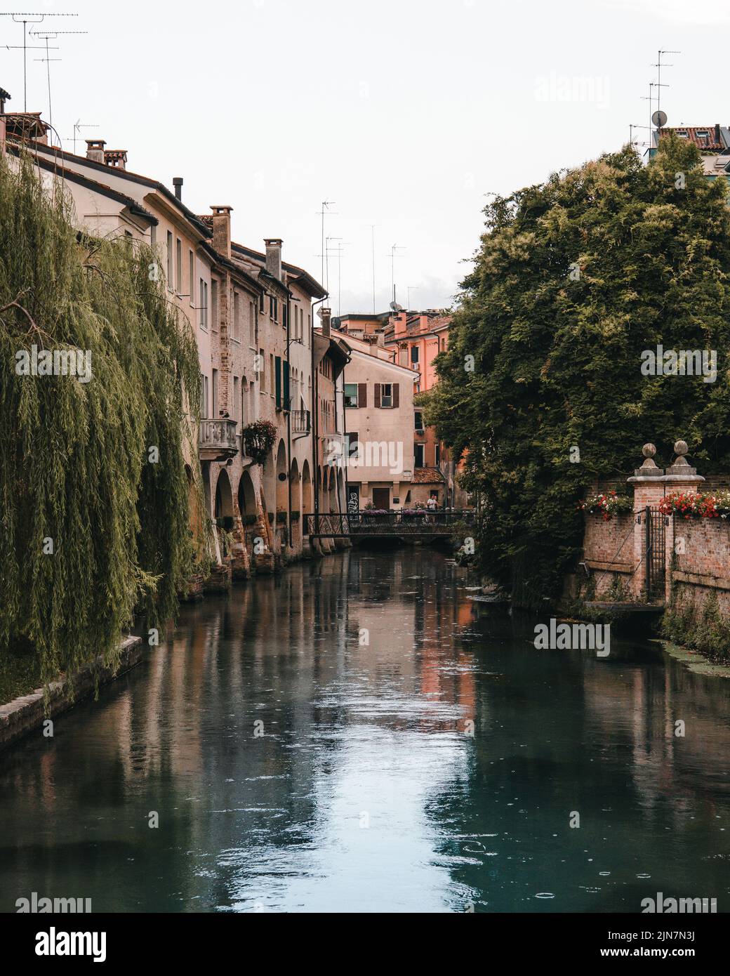 A beautiful view of a river with old buildings and trees under the ...