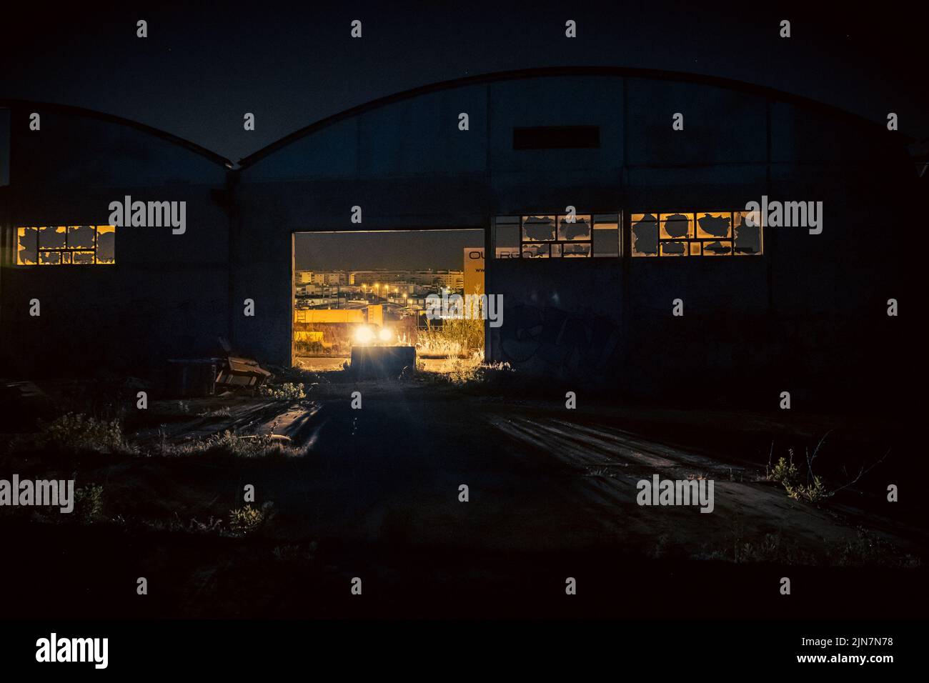 An illuminated abandoned warehouse at night in Portugal Stock Photo - Alamy