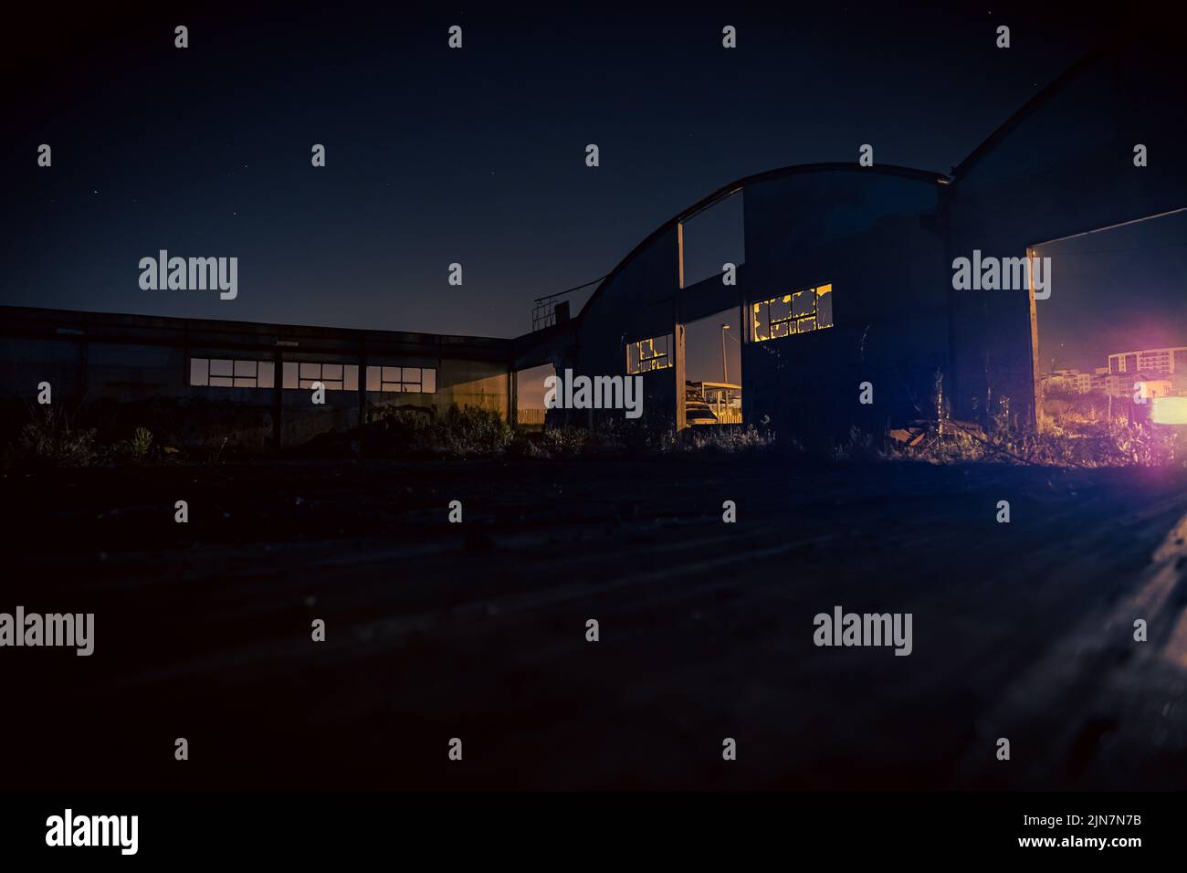 An illuminated abandoned warehouse at night in Portugal Stock Photo - Alamy