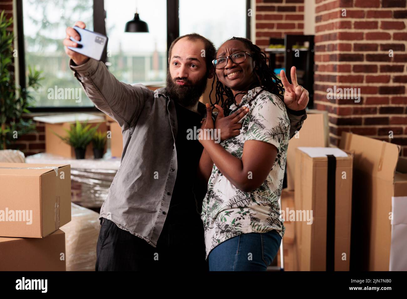 Video happy diverse couple unpacking hi-res stock photography and ...