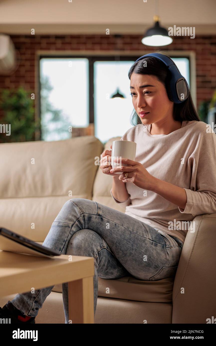 Asian woman at home watching online movie streaming subscription ...